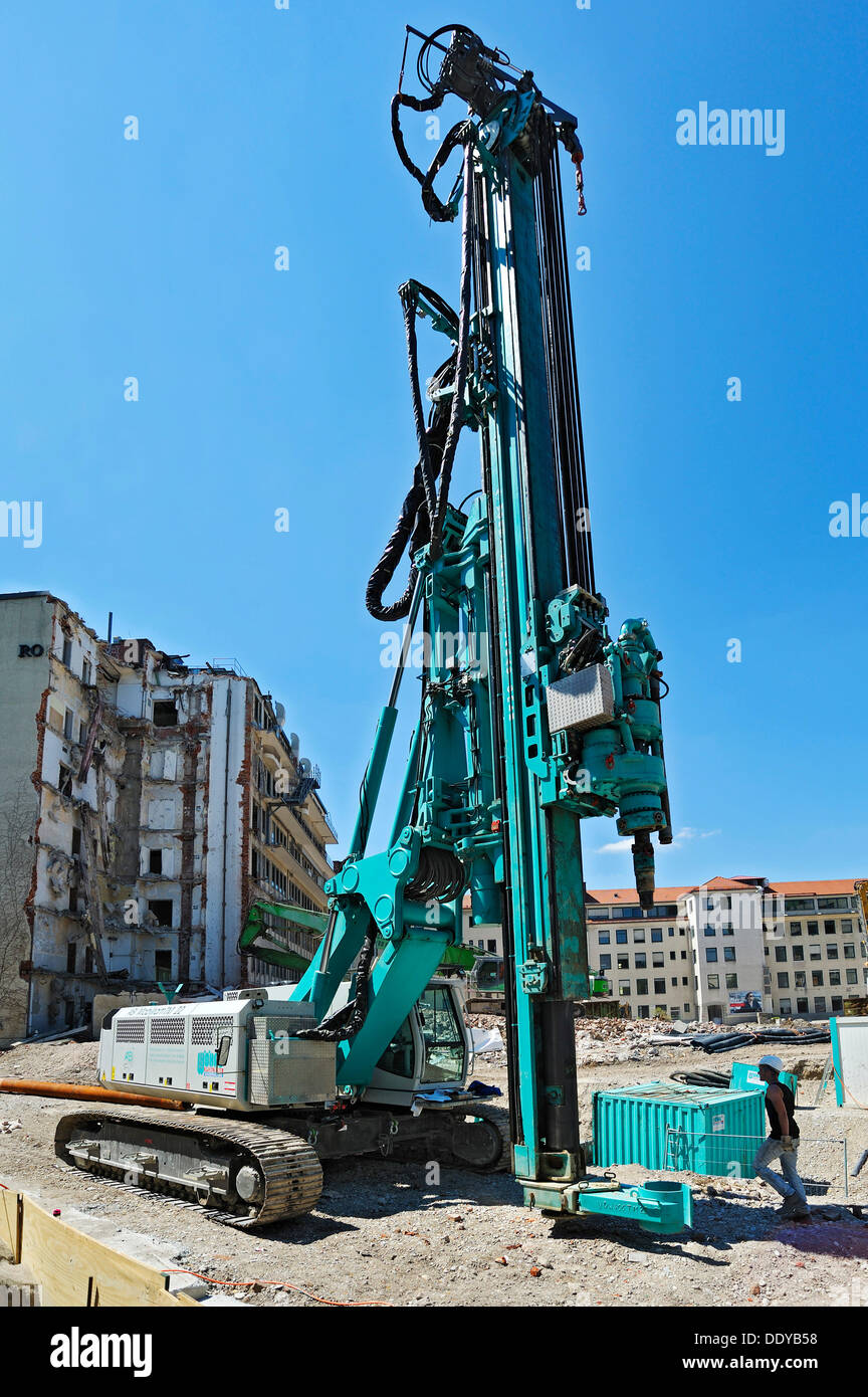 Demolition of houses, machine for drilling of large holes in the ground ...