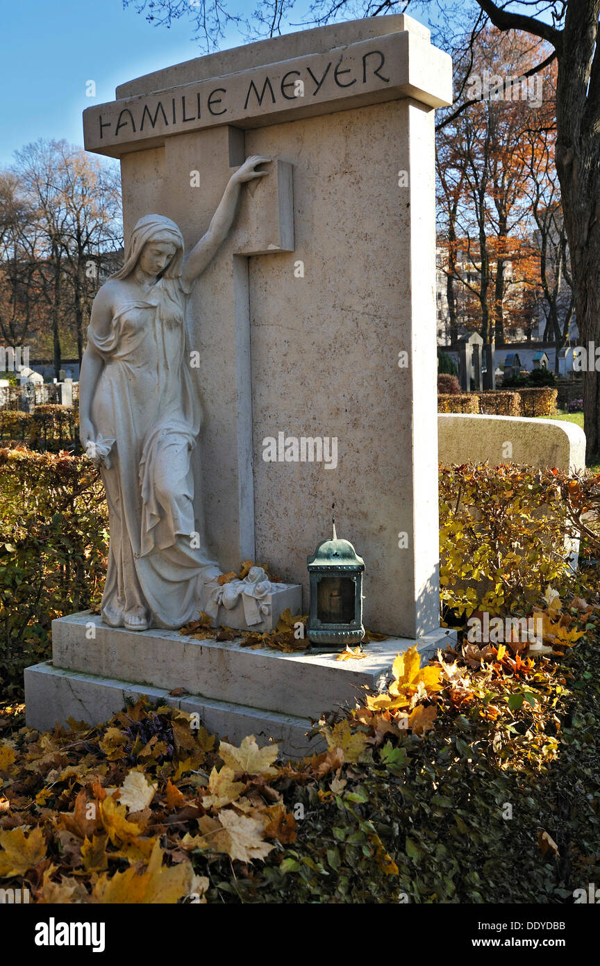 Female figure on grave with autumn leaves, Ostfriedhof, East Cemetery ...