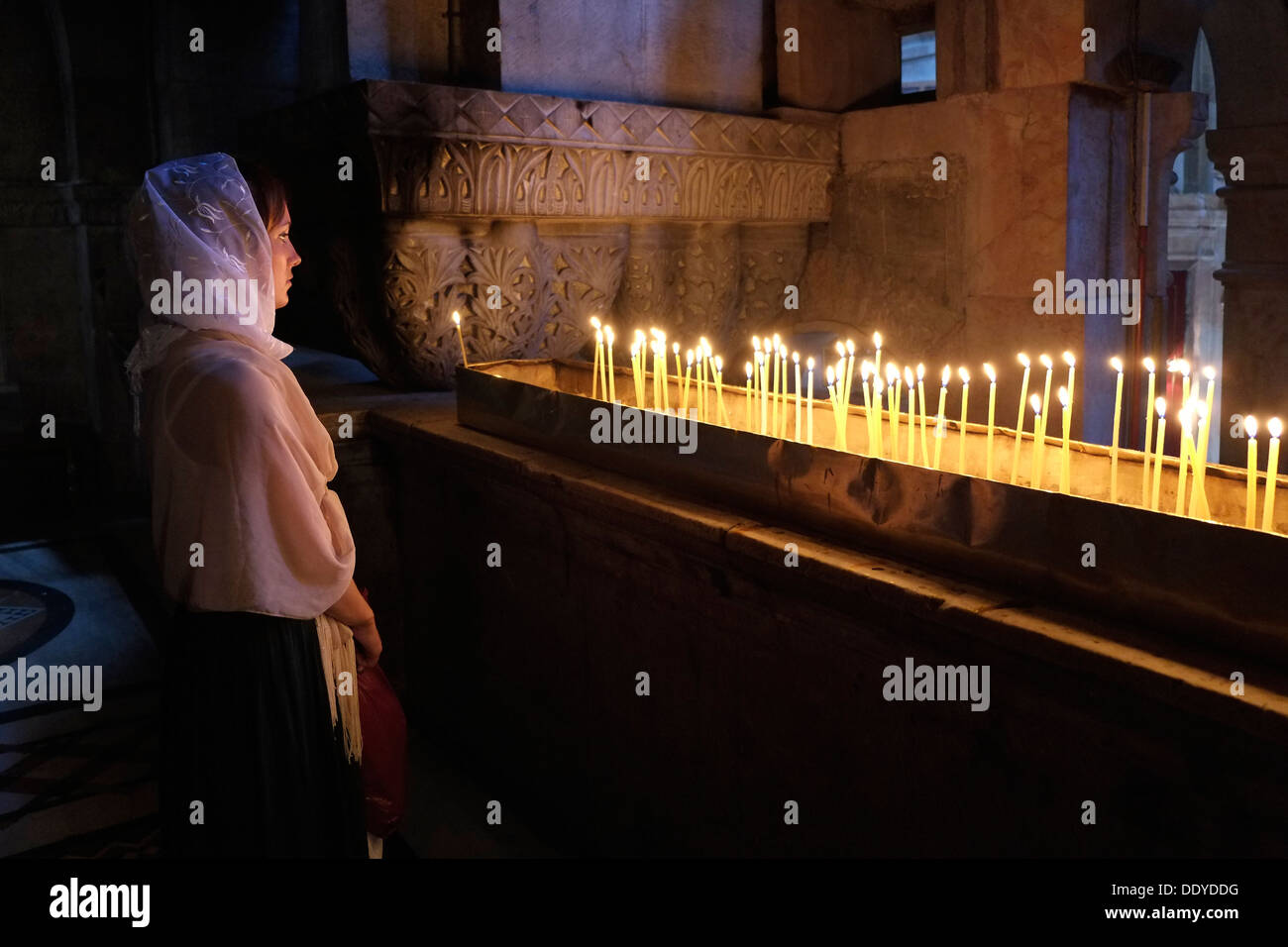 A Christian devotee praying during a procession inside the Church of ...