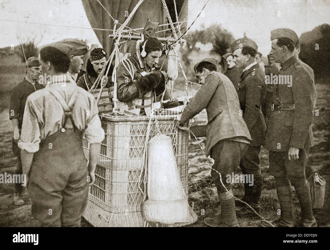 Observer of a kite-balloon testing the telephone before ascending ...