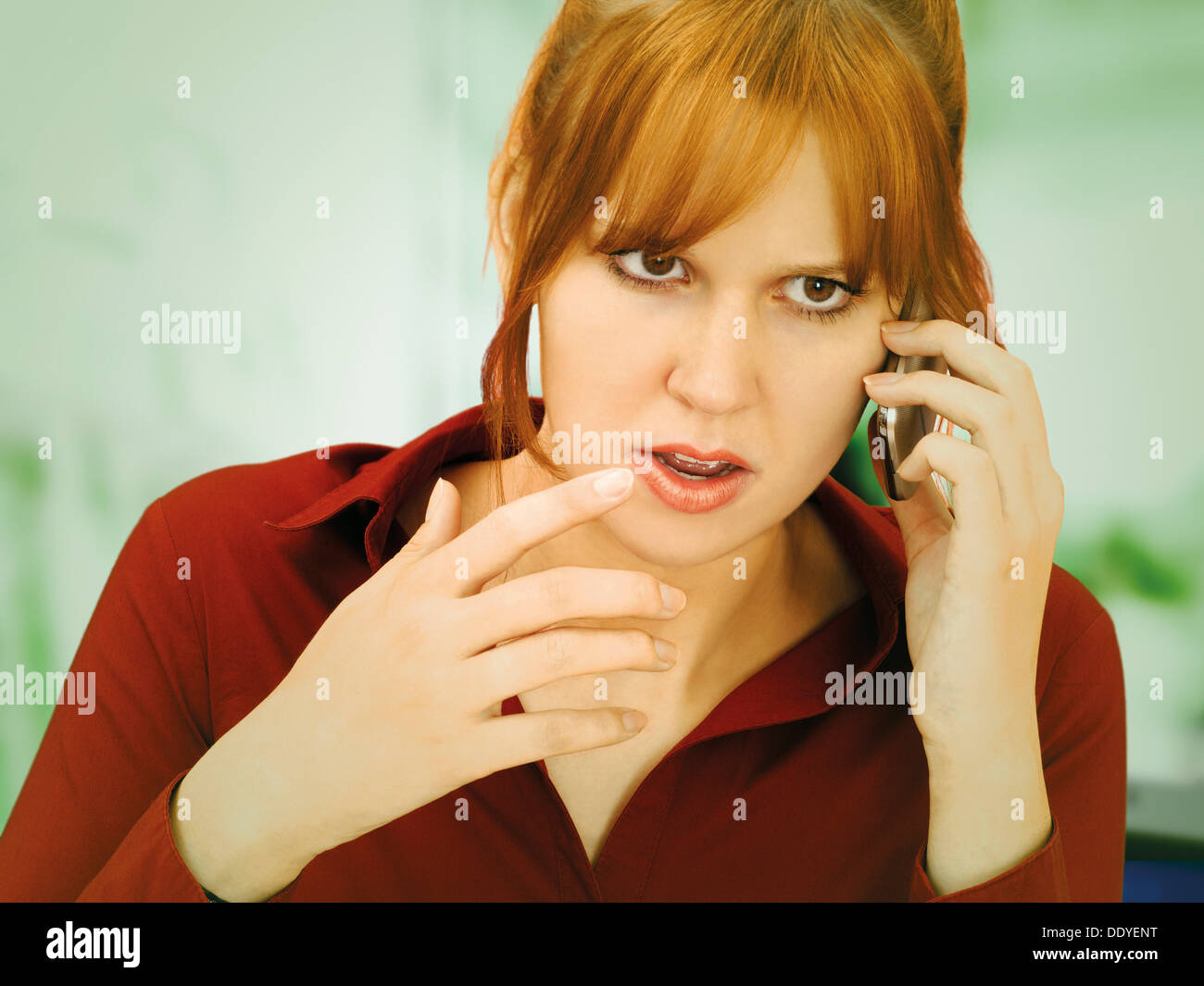 Gesticulating, angry businesswoman with a mobile phone Stock Photo - Alamy