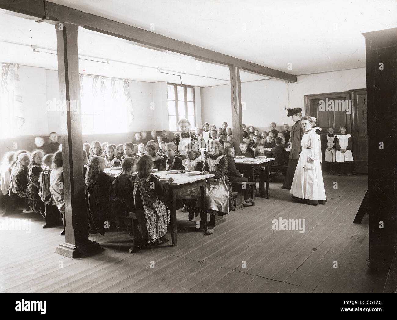 Poor children are served free meals in the refectory, Albano school ...