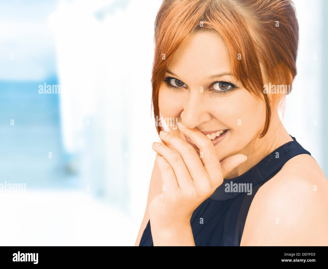 Portrait of a young woman giggling Stock Photo - Alamy
