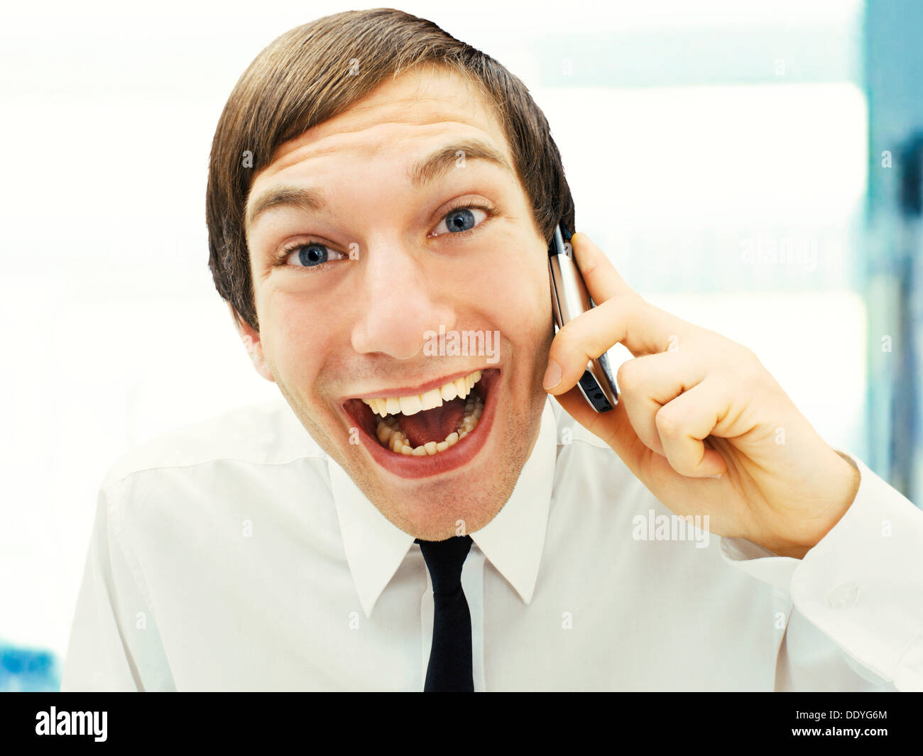 Happy businessman speaking phone cheering hi-res stock photography and ...