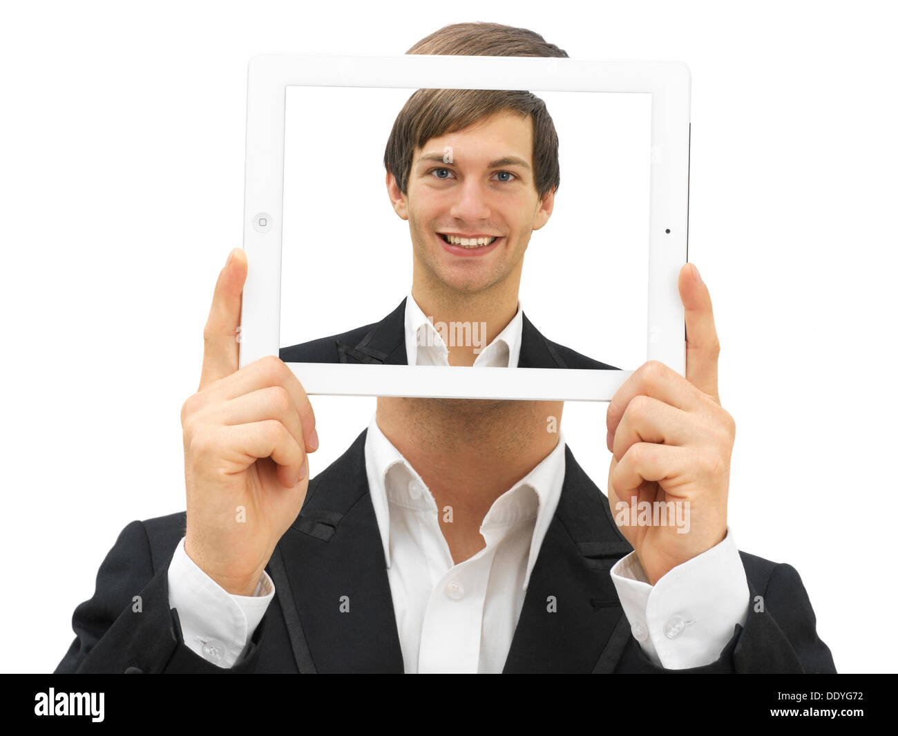 Businessman holding an iPad with a self portrait in front of his face ...