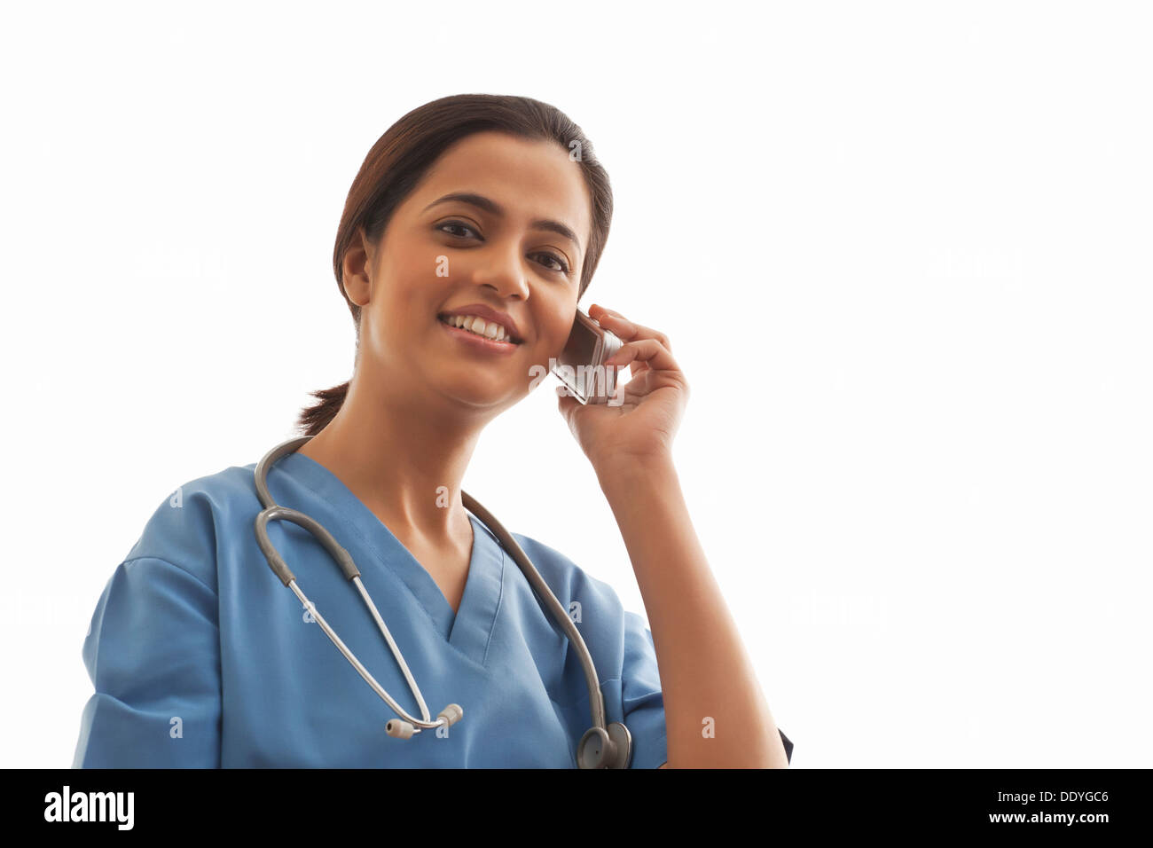 Portrait of a female surgeon using cell phone isolated over white ...