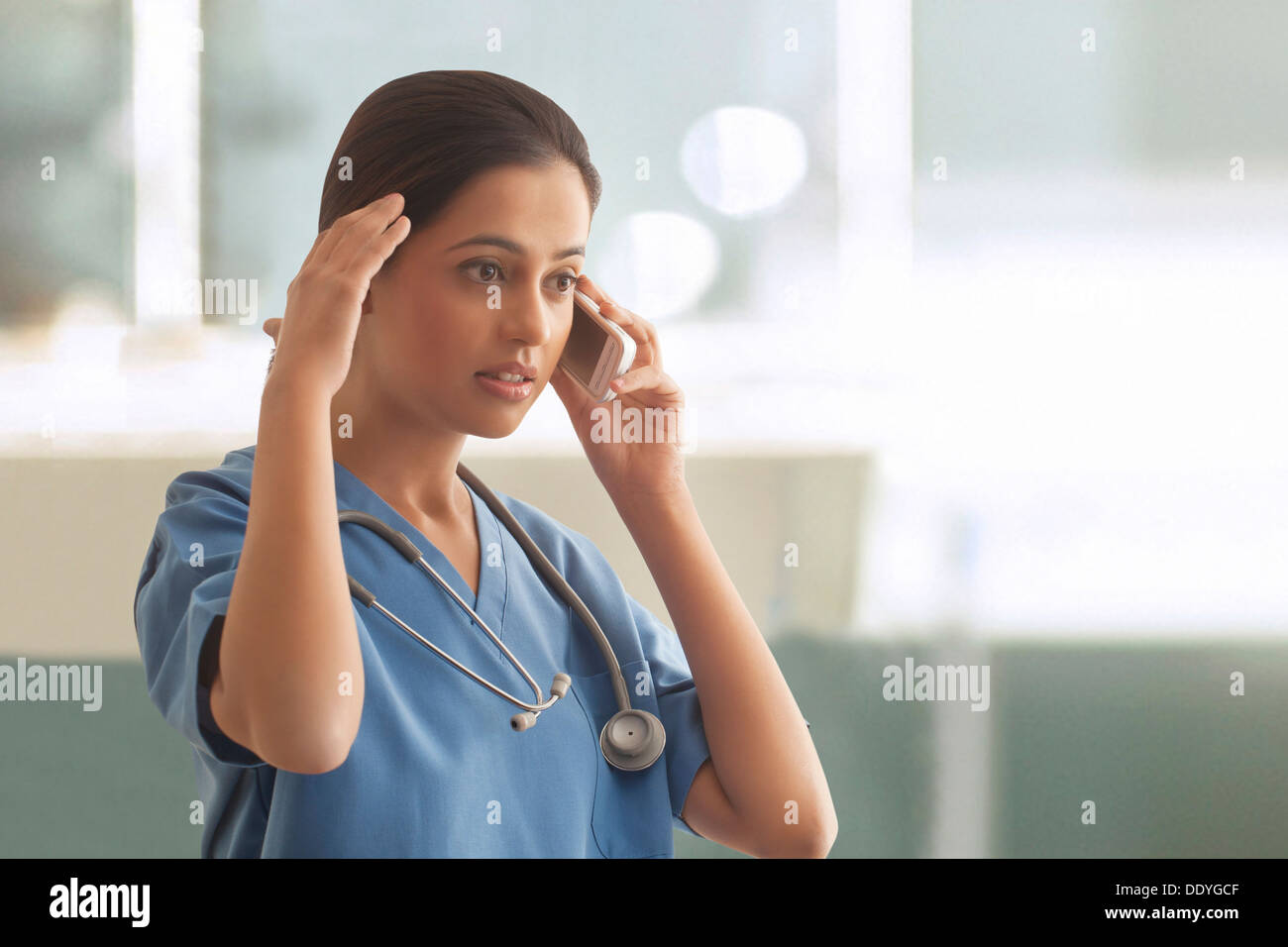 An upset young surgeon using cell phone in hospital Stock Photo - Alamy