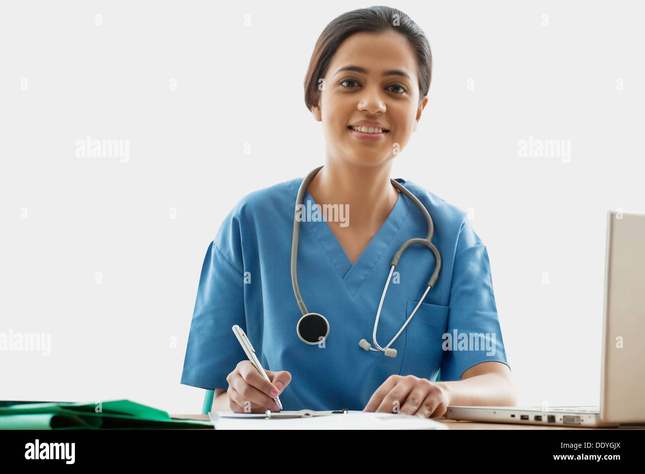 Portrait of young female surgeon writing notes at desk Stock Photo - Alamy