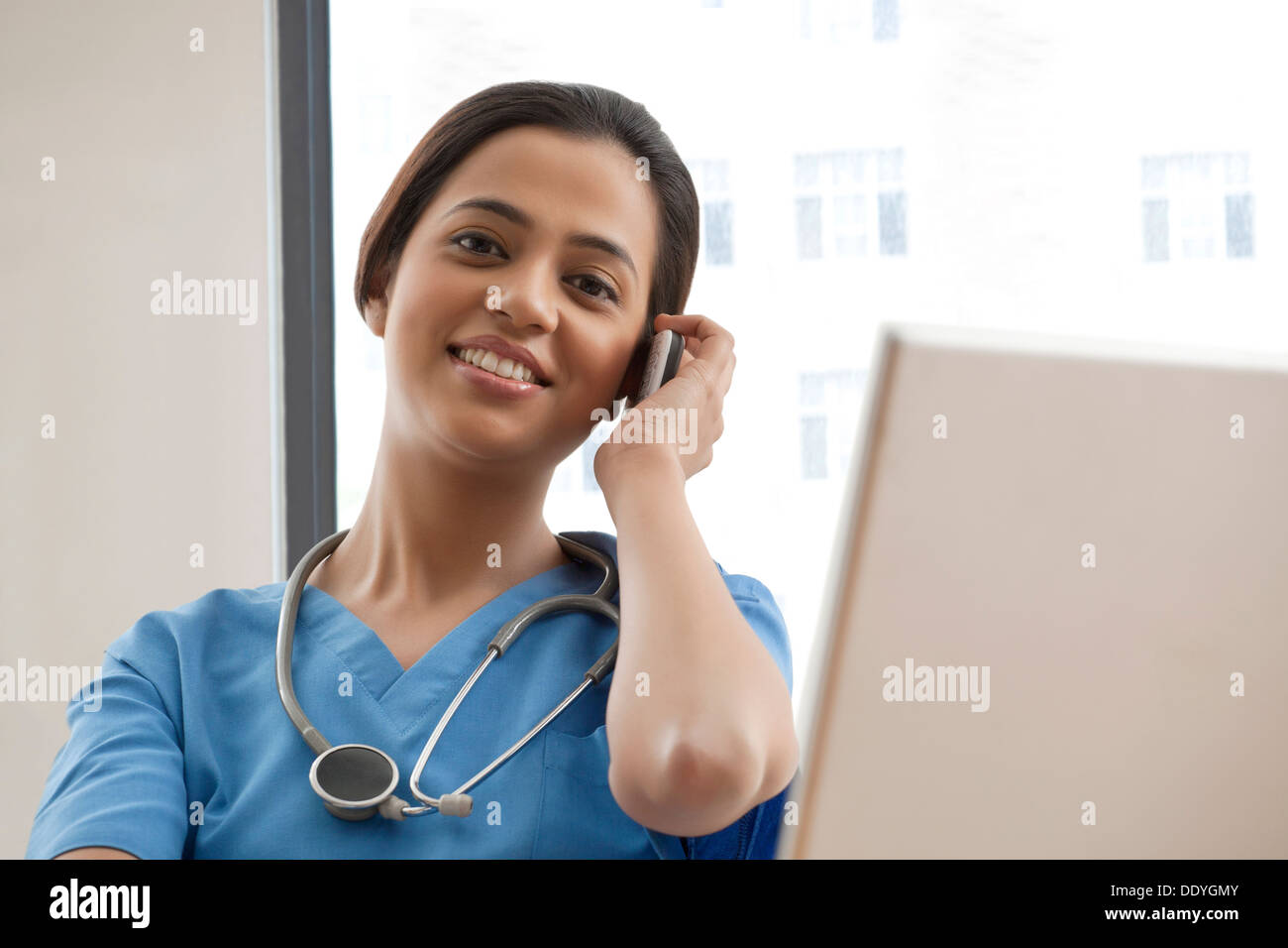 Smiling surgeon using cell hi-res stock photography and images - Alamy
