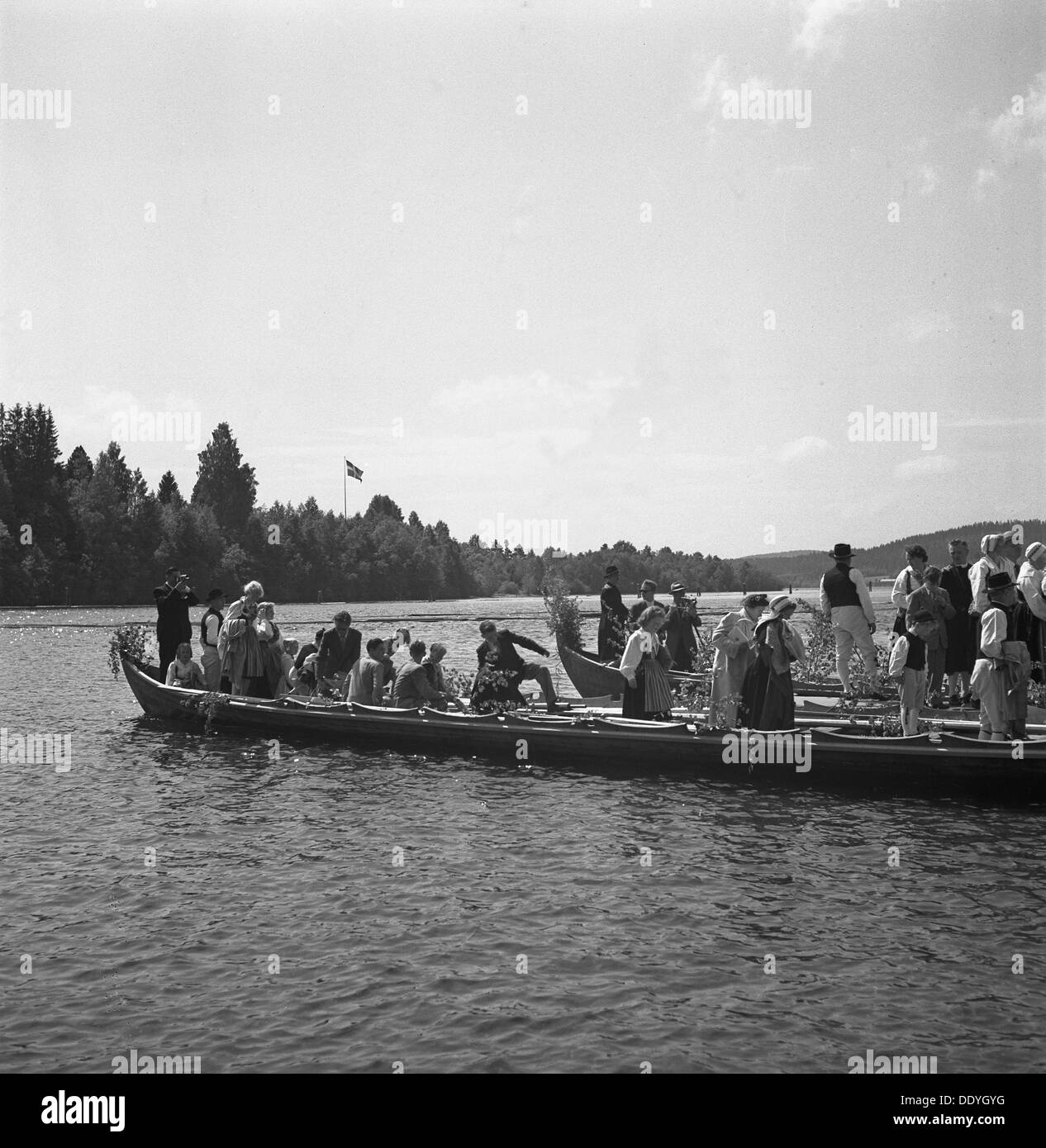 People arrive in long boats, called church boats, for the Midsummer ...