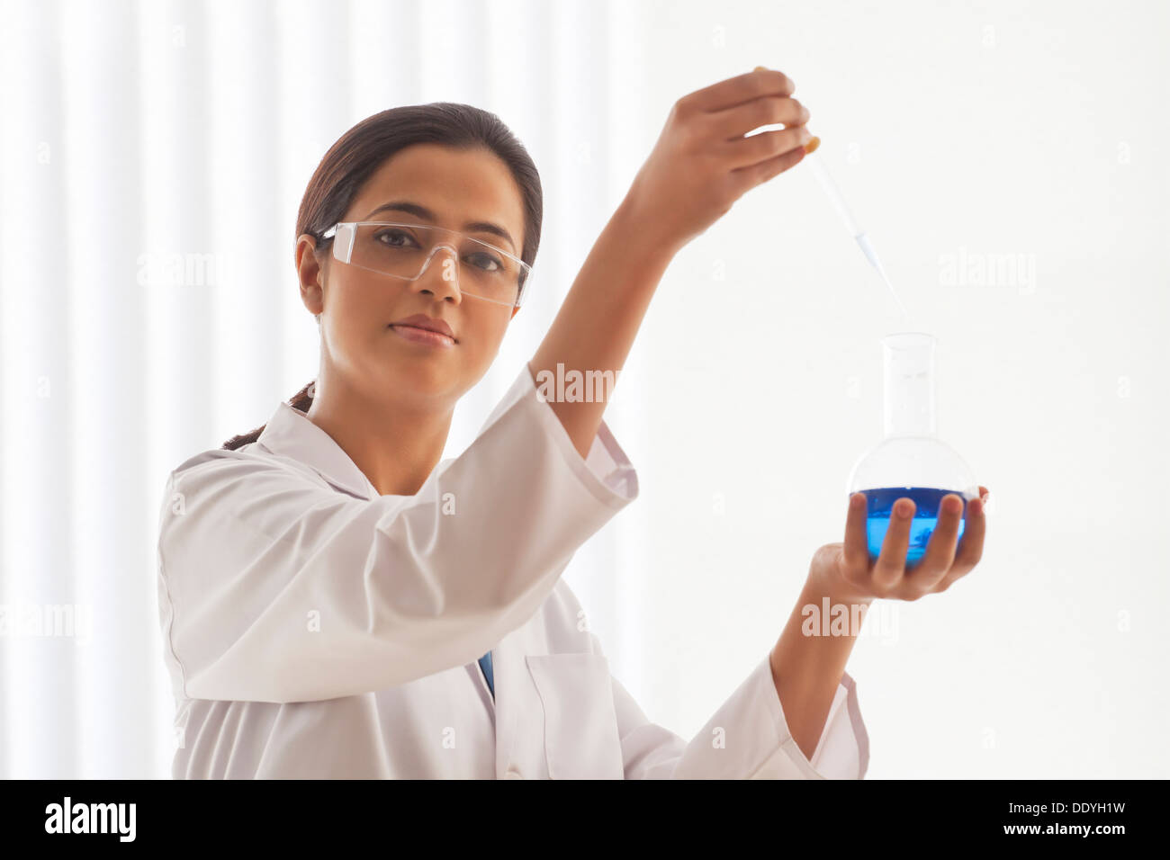 Portrait of confident young female scientist experimenting in lab Stock ...