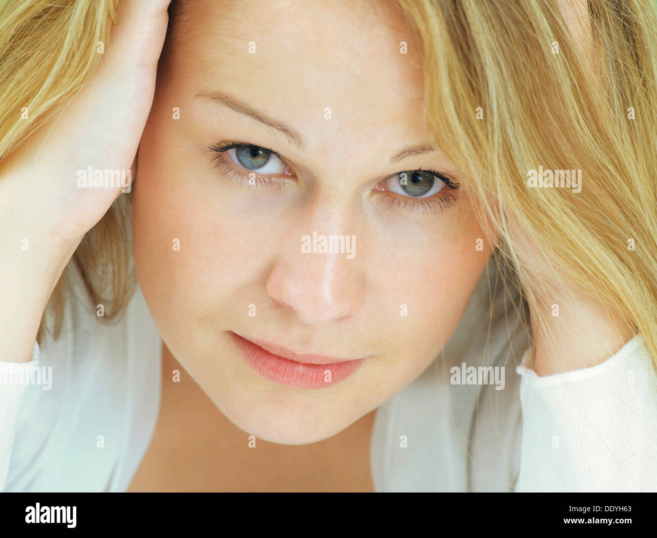 Portrait of a young woman with a serious face Stock Photo - Alamy