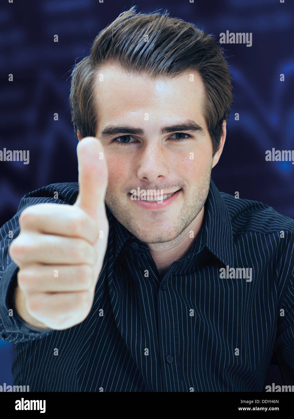 Businessman giving thumbs-up Stock Photo - Alamy
