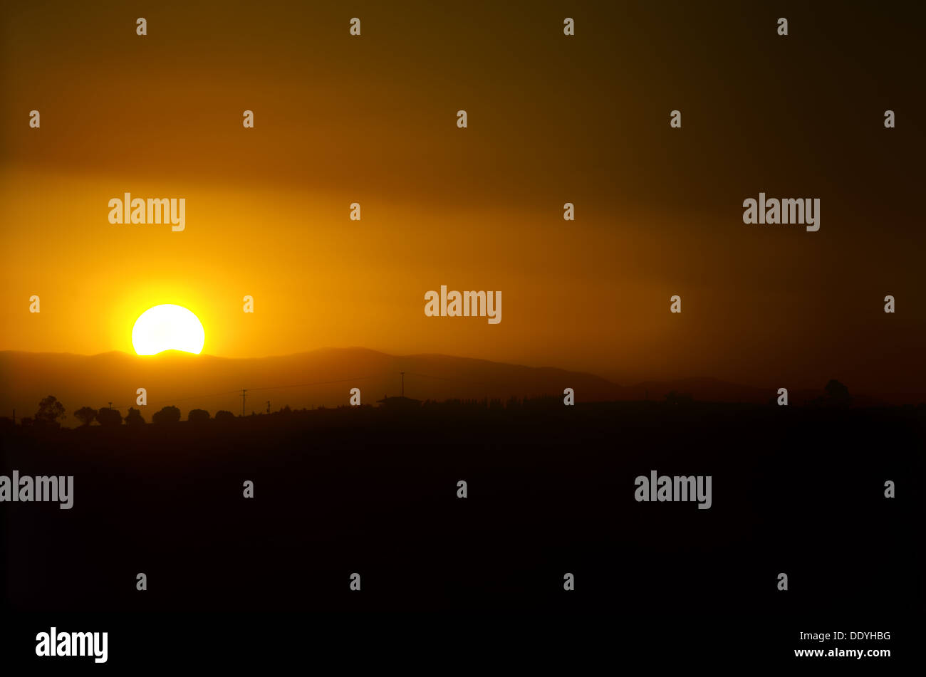 Sunset over village Stock Photo - Alamy