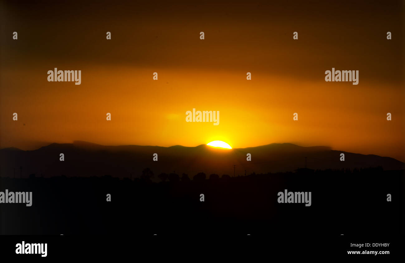 Sunset over village Stock Photo - Alamy