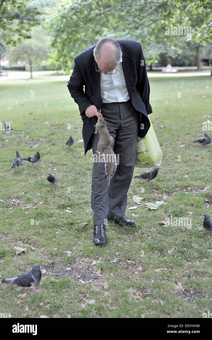 man feeding squirrel in saint james park, london Stock Photo - Alamy