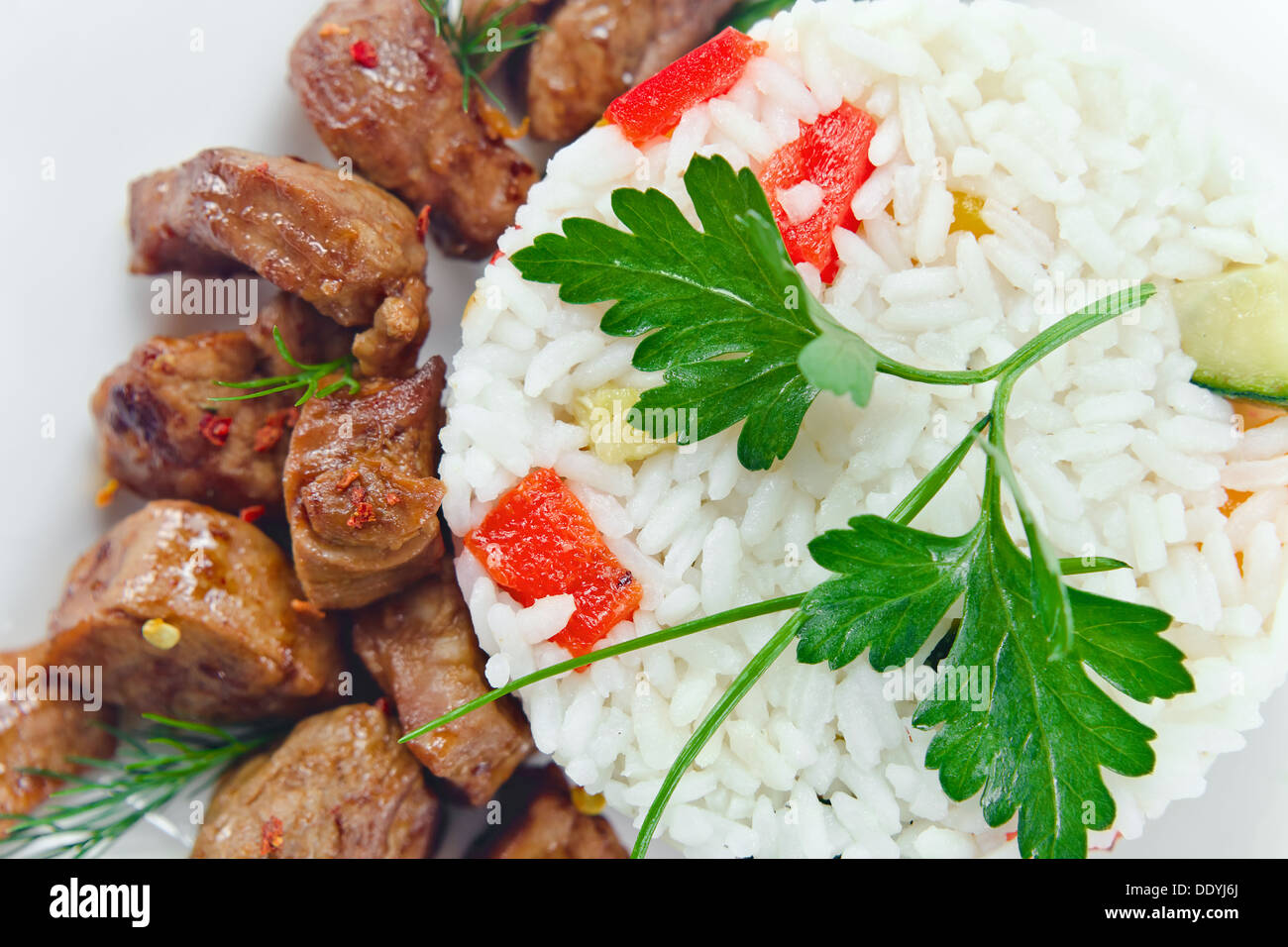 Stewed mutton with rice on a white plate Stock Photo - Alamy