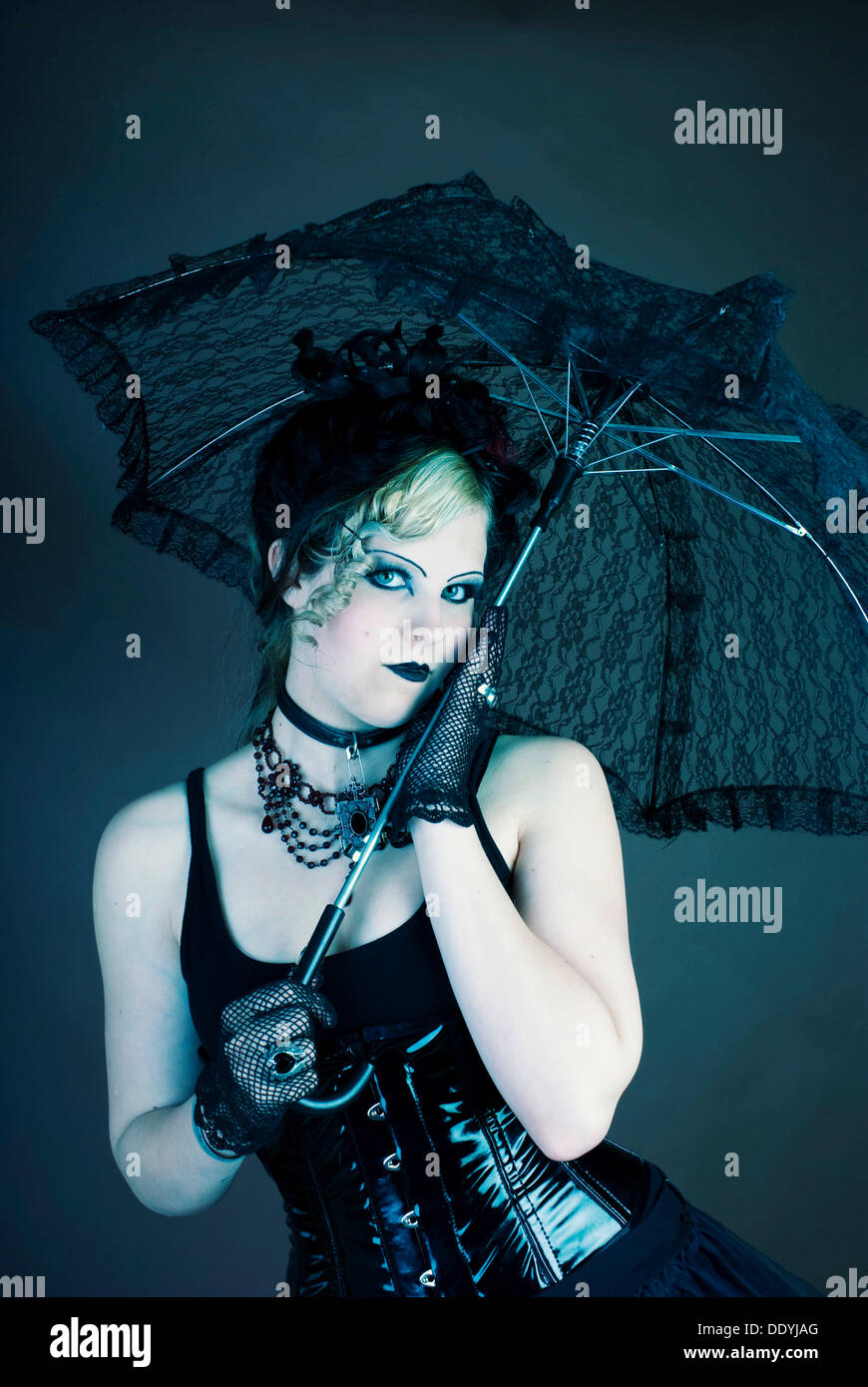 Woman, Gothic, serious, parasol and glossy corset Stock Photo - Alamy