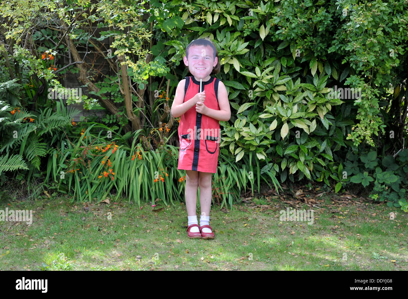 little girl wearing wayne rooney mask Stock Photo - Alamy