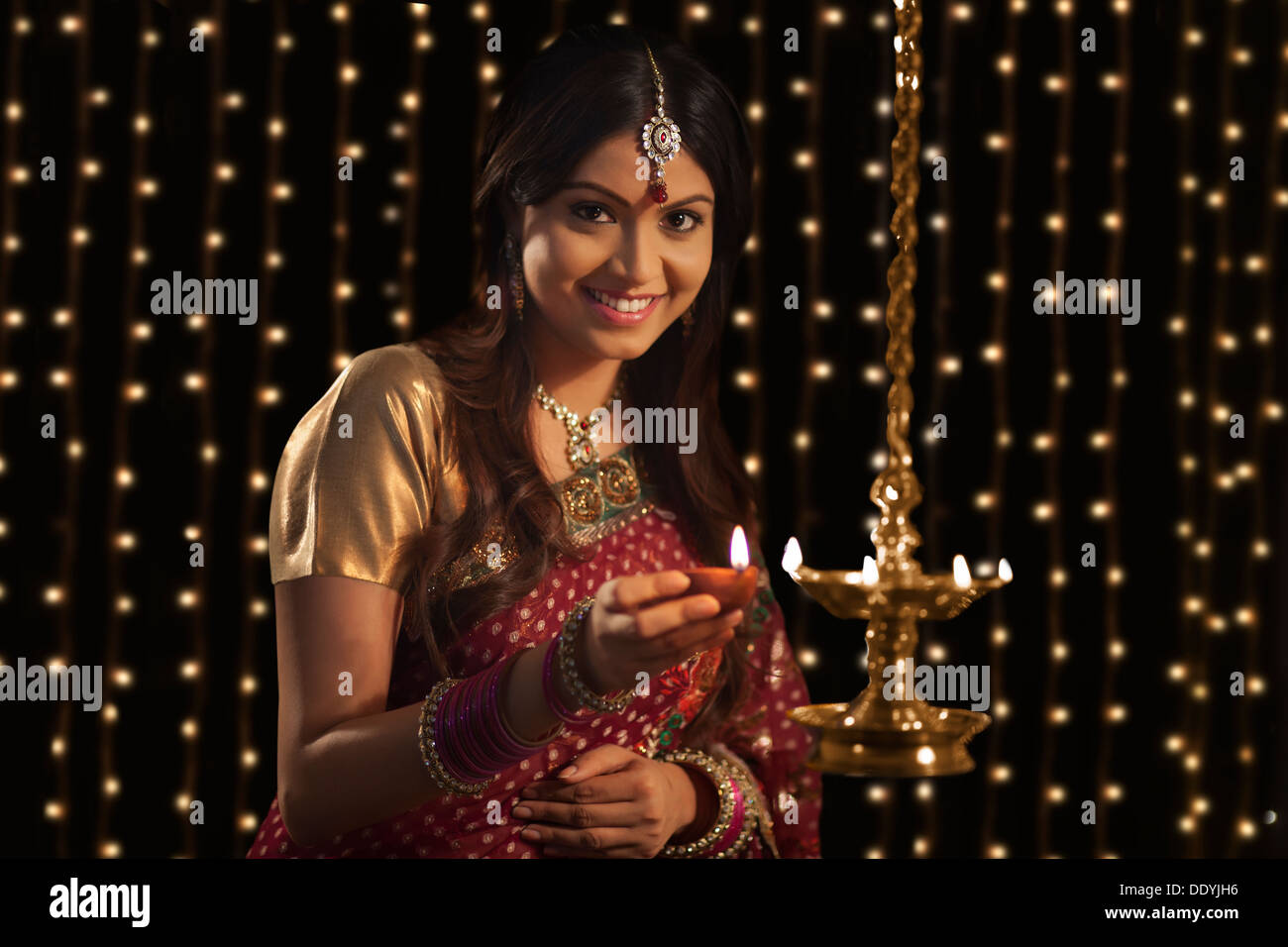 Portrait of woman with a diya Stock Photo - Alamy