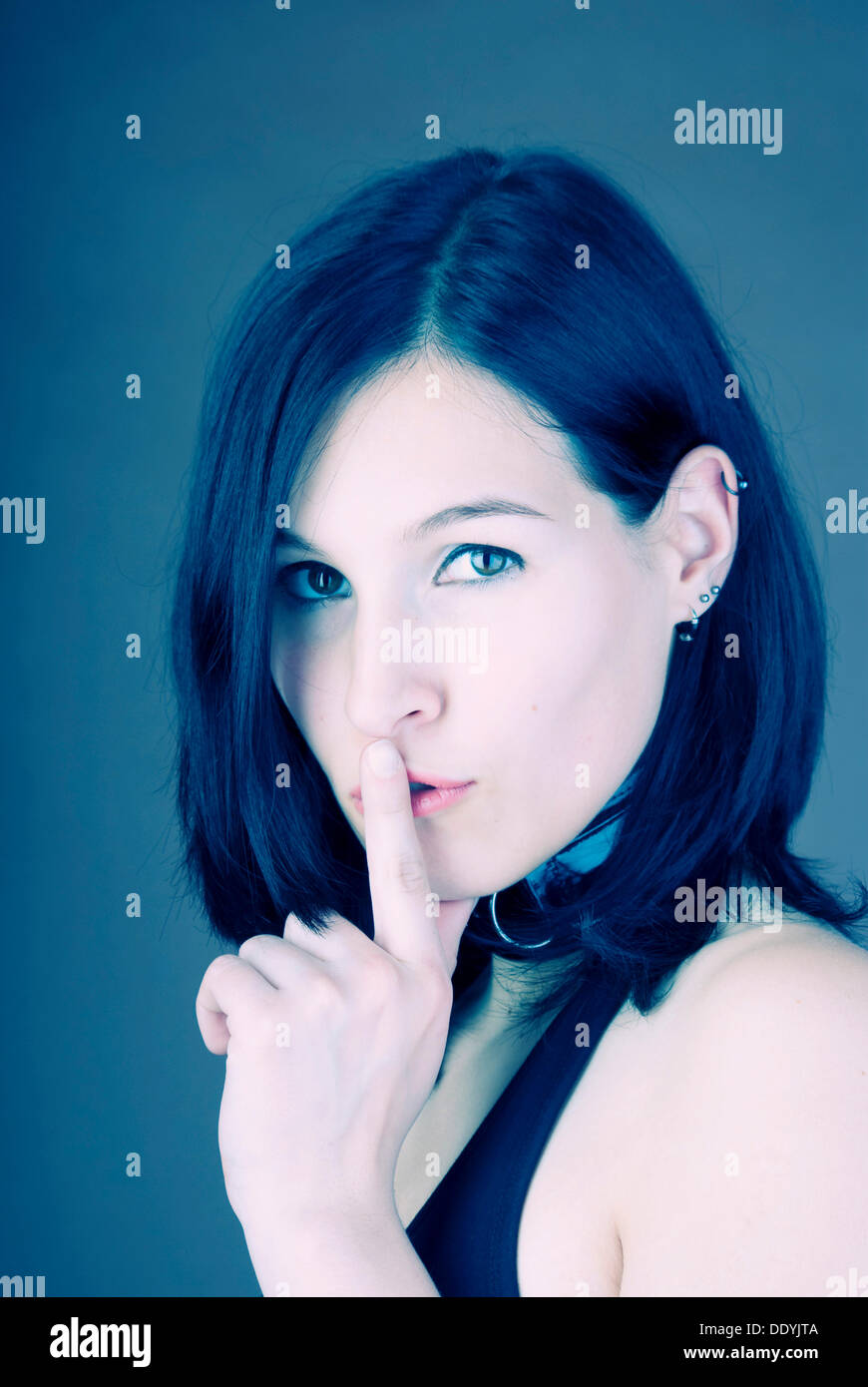 Woman, Gothic look, portrait, pierced ears, finger touching lips ...