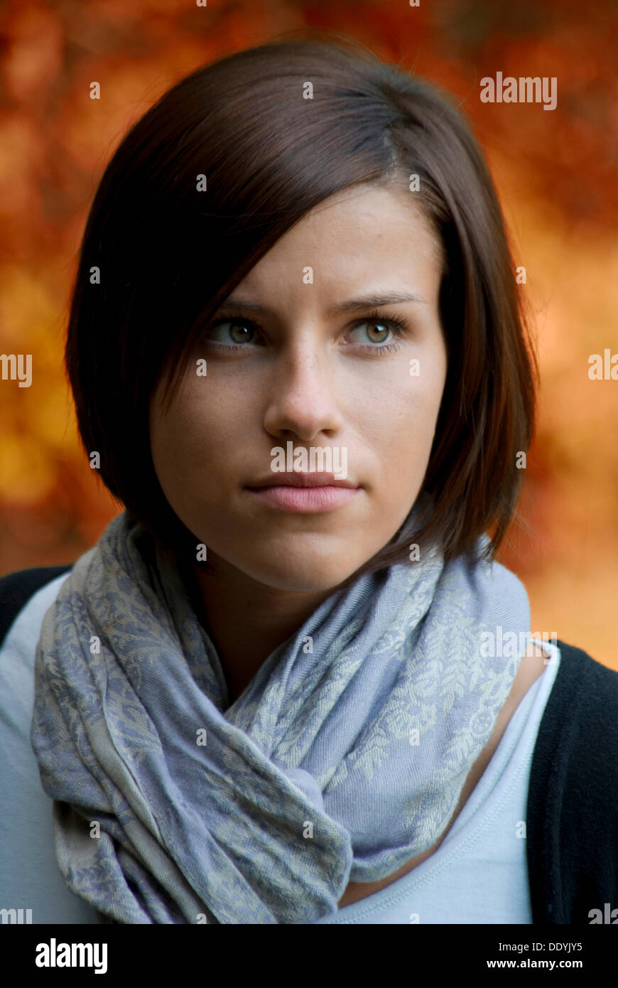 Portrait, standing young woman, sad Stock Photo - Alamy