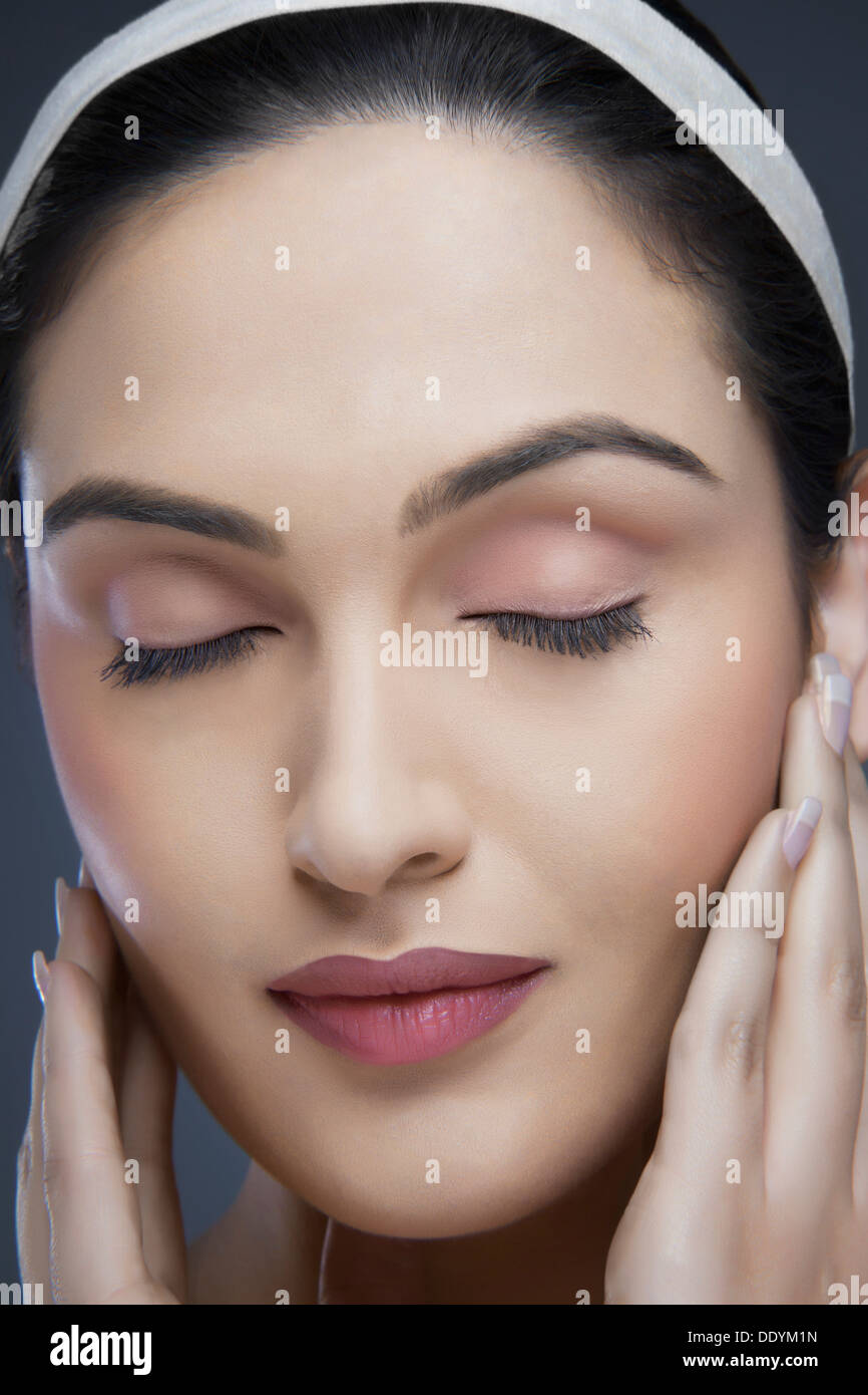 Calm woman touching face hi-res stock photography and images - Alamy