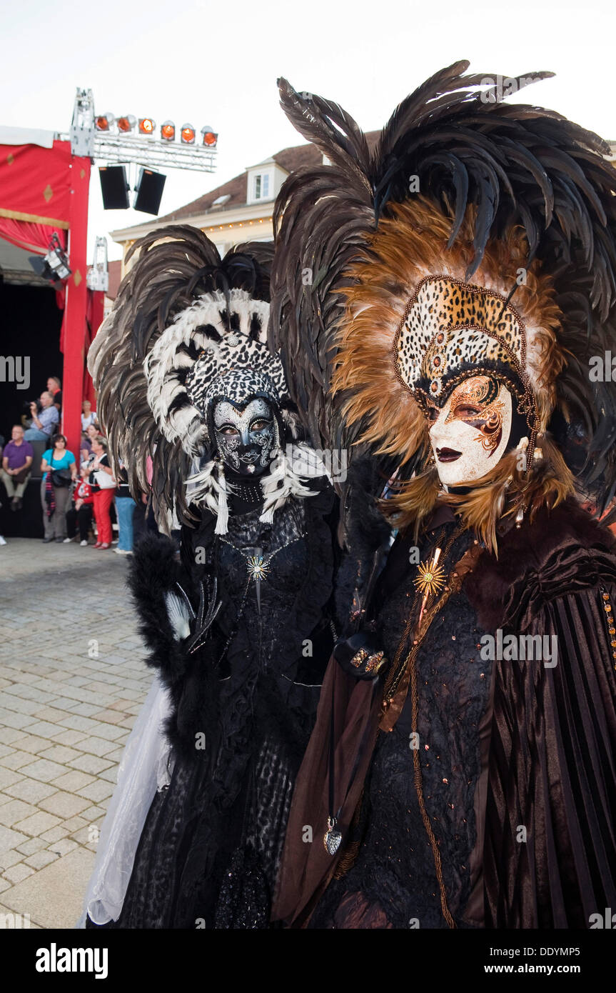 People in Baroque costumes, masks and elaborate headdresses with ...
