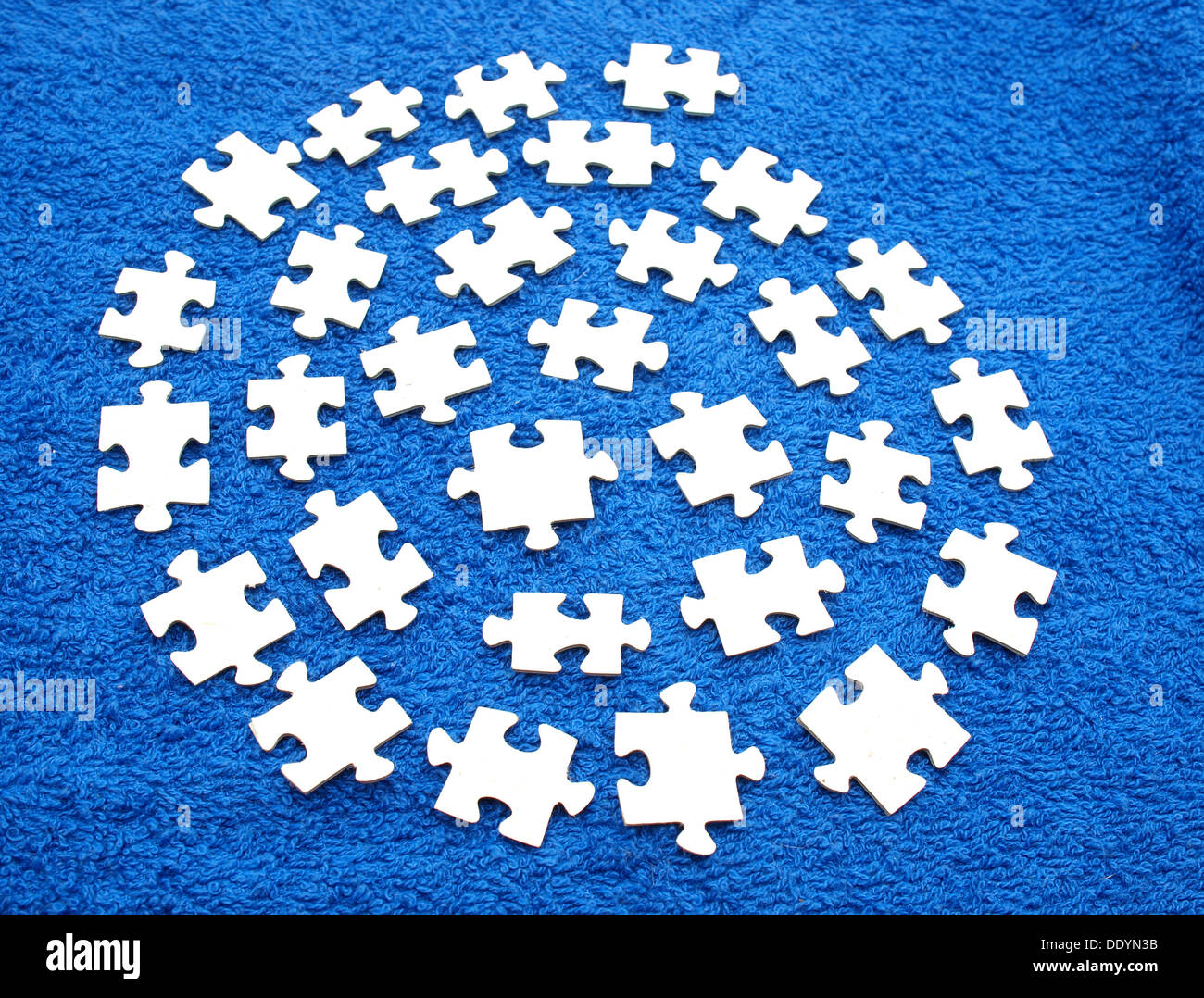 Puzzle on a dark blue fabric Stock Photo - Alamy