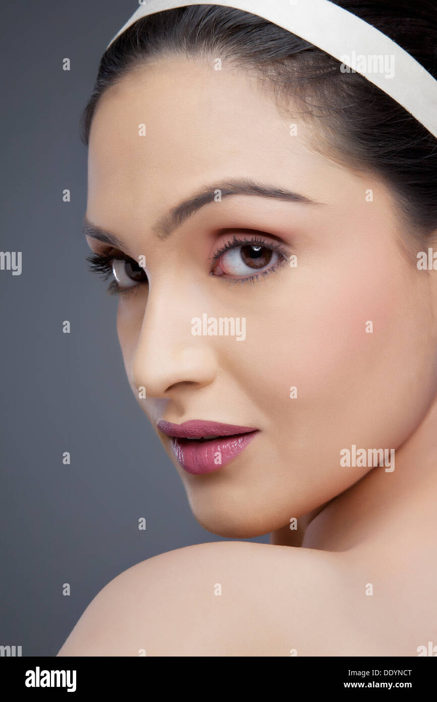 Portrait of an attractive woman looking over shoulder Stock Photo - Alamy