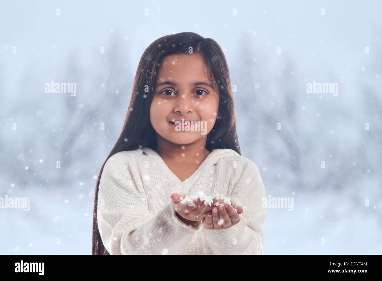 Little girl catching snow Stock Photo - Alamy