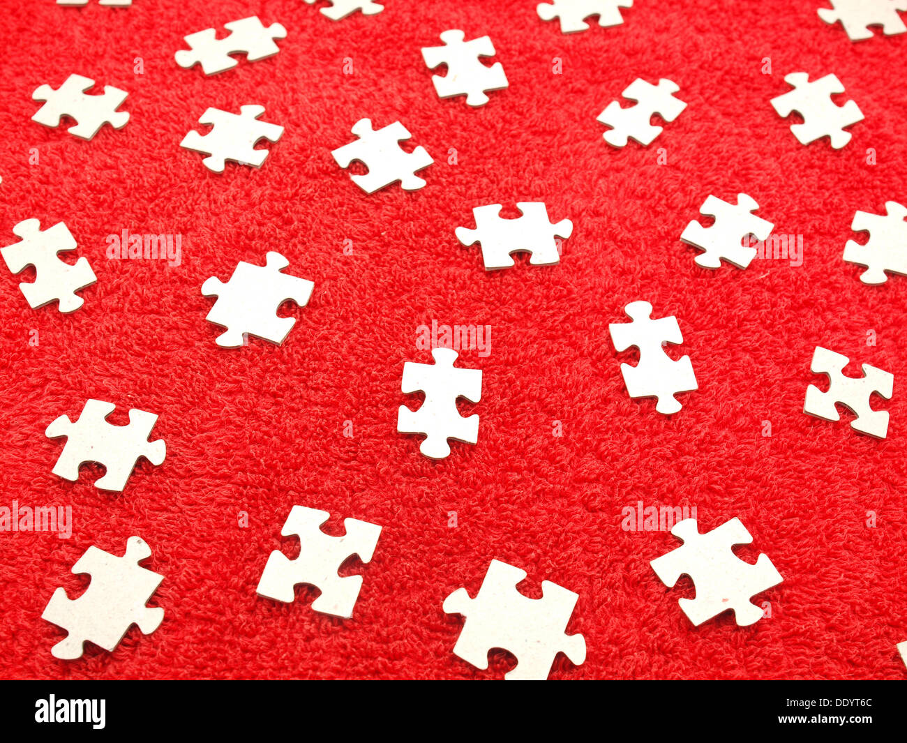 Puzzle on a red fabric Stock Photo - Alamy