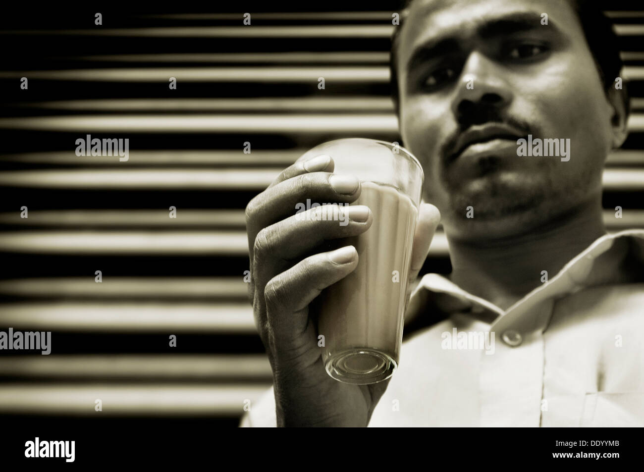 Portrait of Indian mid adult man having glass of milk tea Stock Photo ...