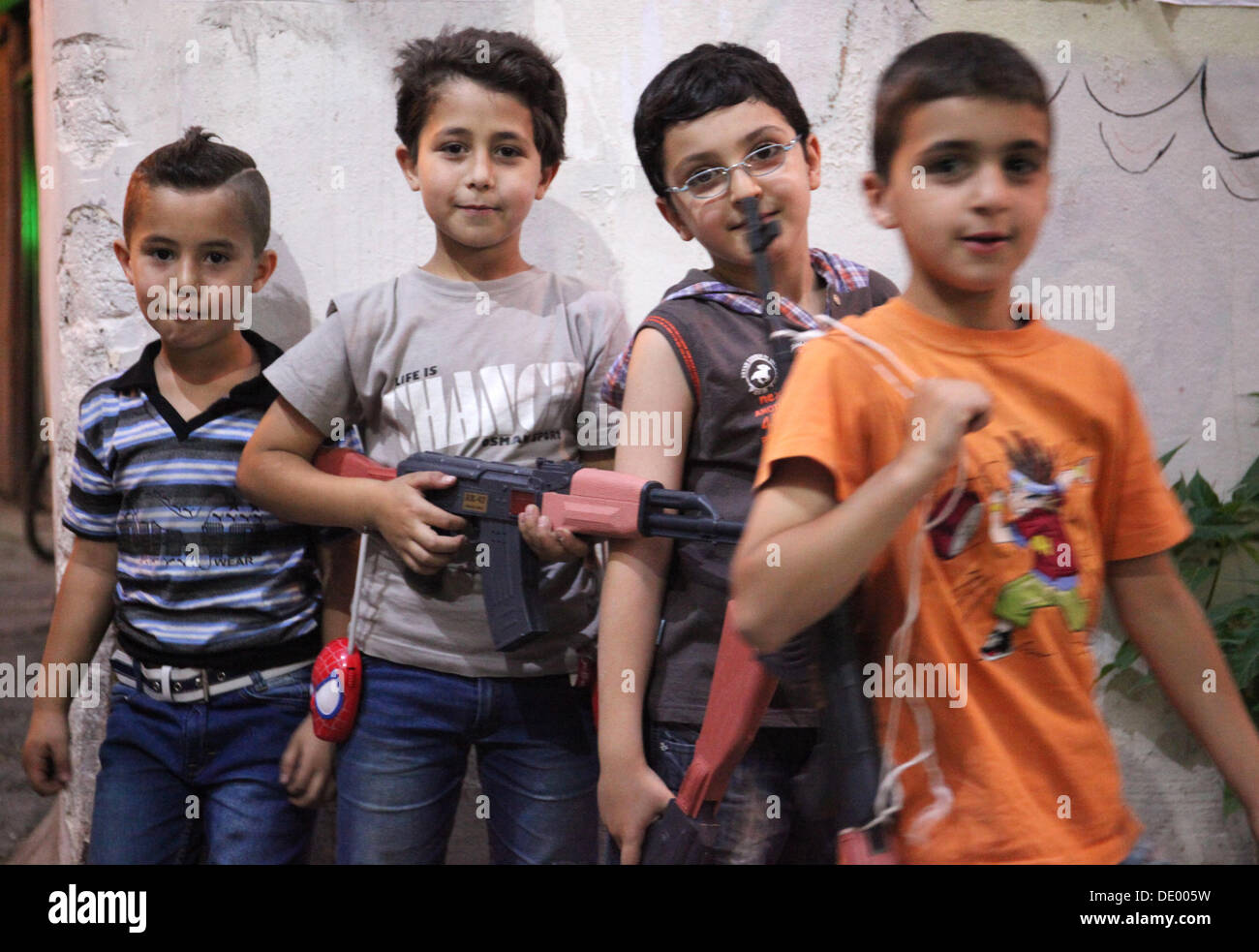 Boys with toys in the shape of Kalashnikov machineguns play in the ...