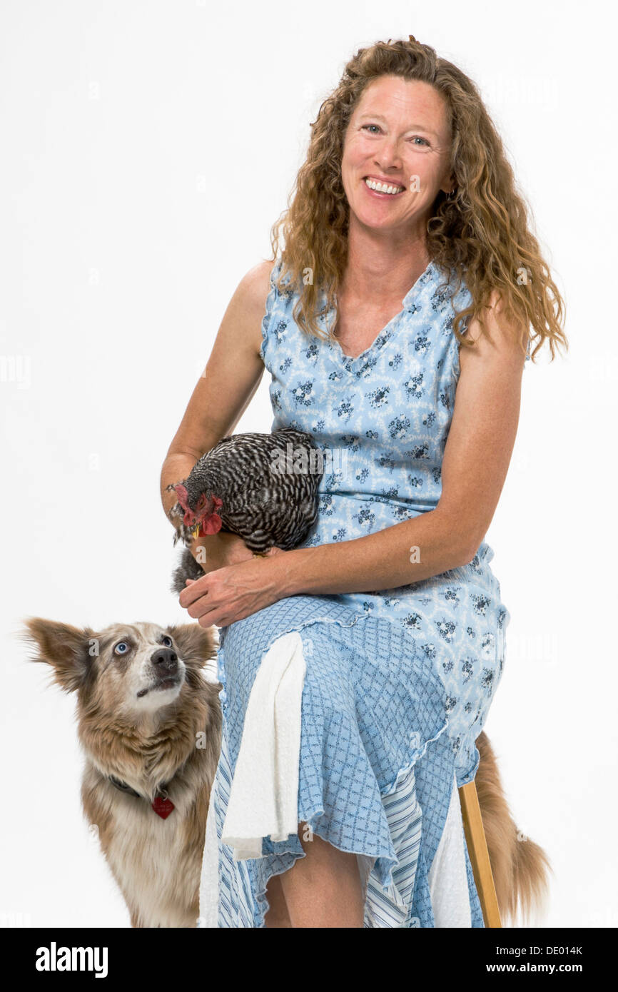 Studio photograph of attractive woman in summer dress with Barred Rocks ...