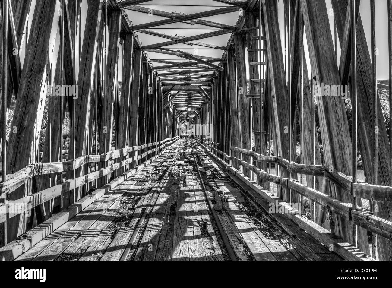 Dramatic, old wooden railway bridge crossing Red Deer river, was used ...