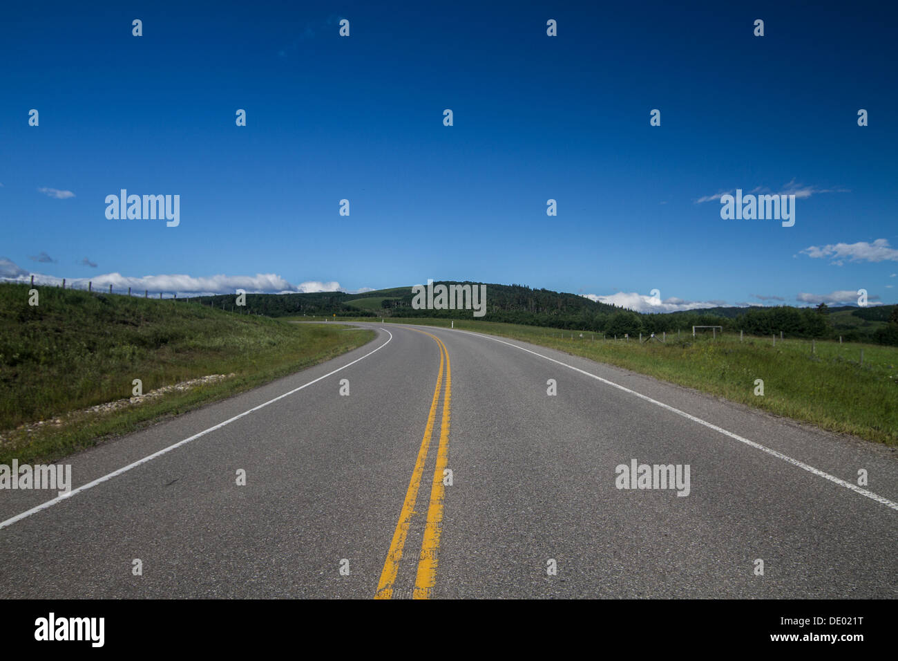 Scenic, dramatic, low level landscape of highway curving to left, with ...
