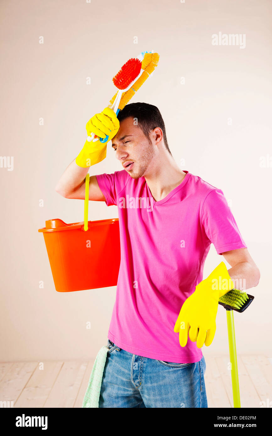 Man looking tired and stressed from cleaning Stock Photo - Alamy
