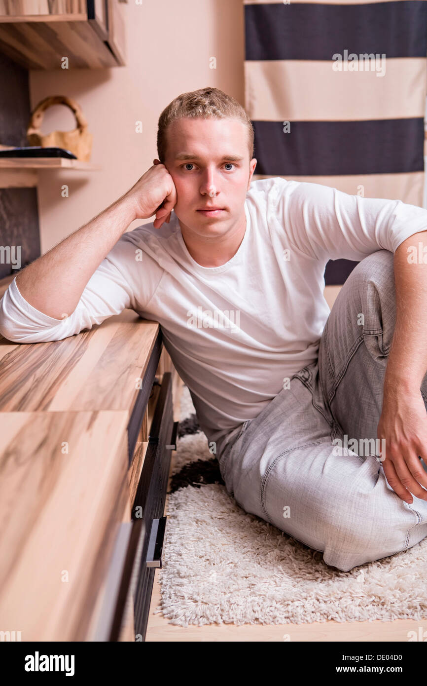 Young man in a living room Stock Photo - Alamy