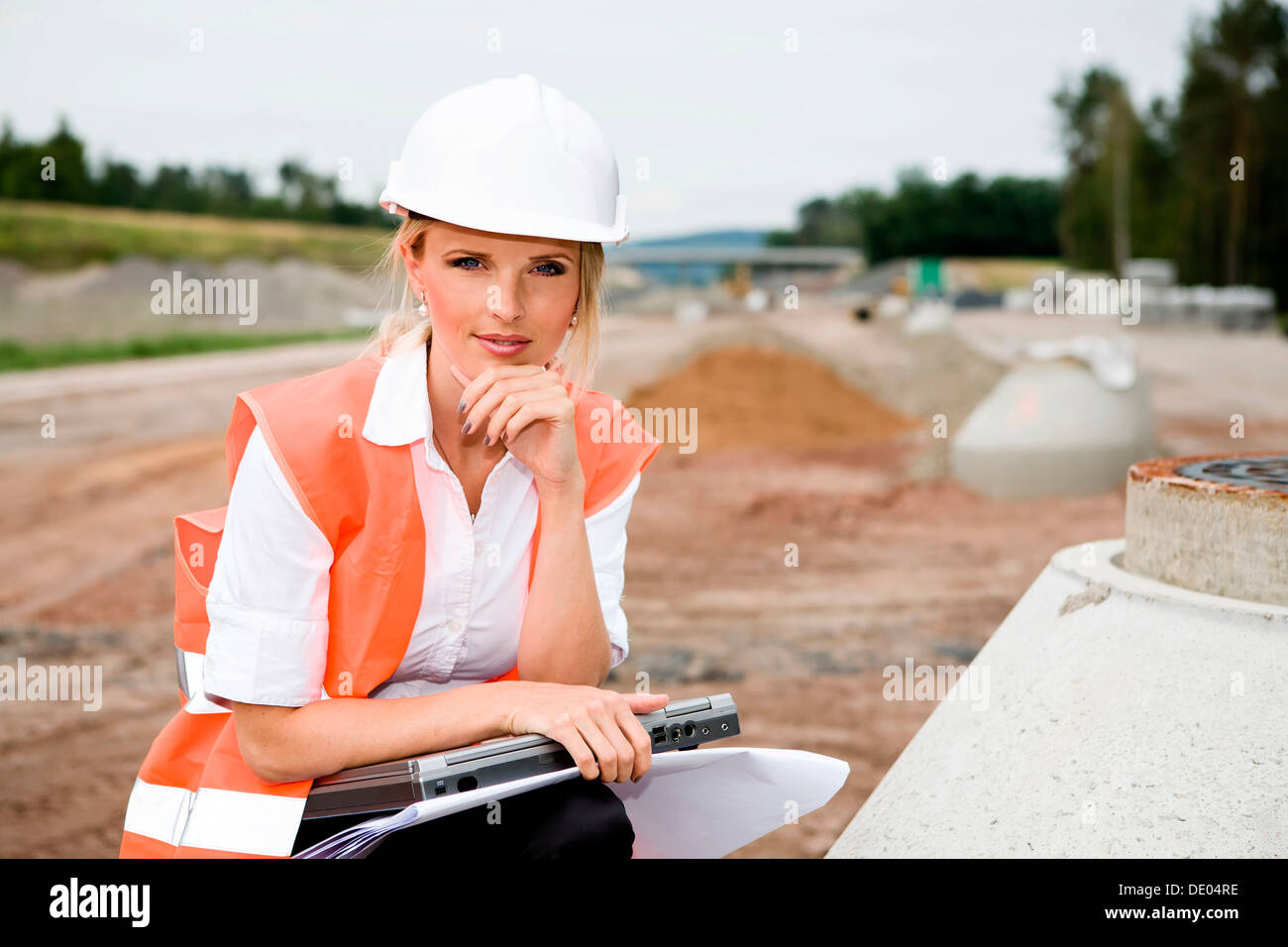 A young female constructor at building of a new motorway Stock Photo ...