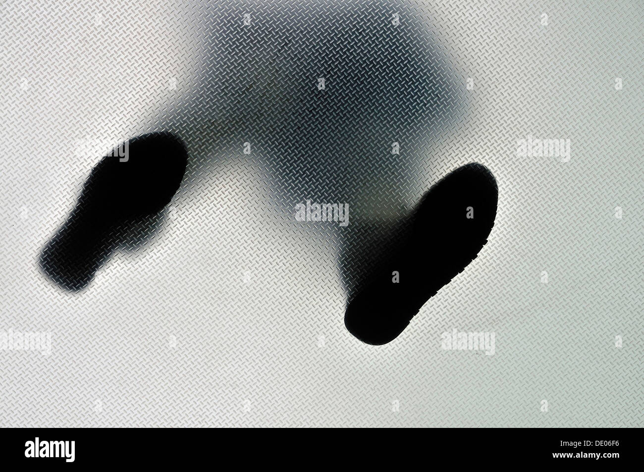 Anonymous person standing with feet wide apart, from below Stock Photo ...