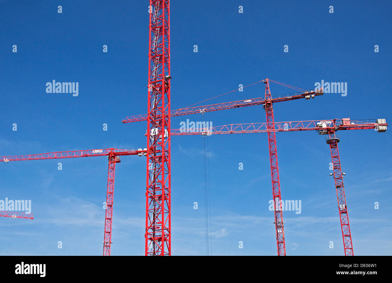 Red construction cranes, boom in the construction industry Stock Photo ...