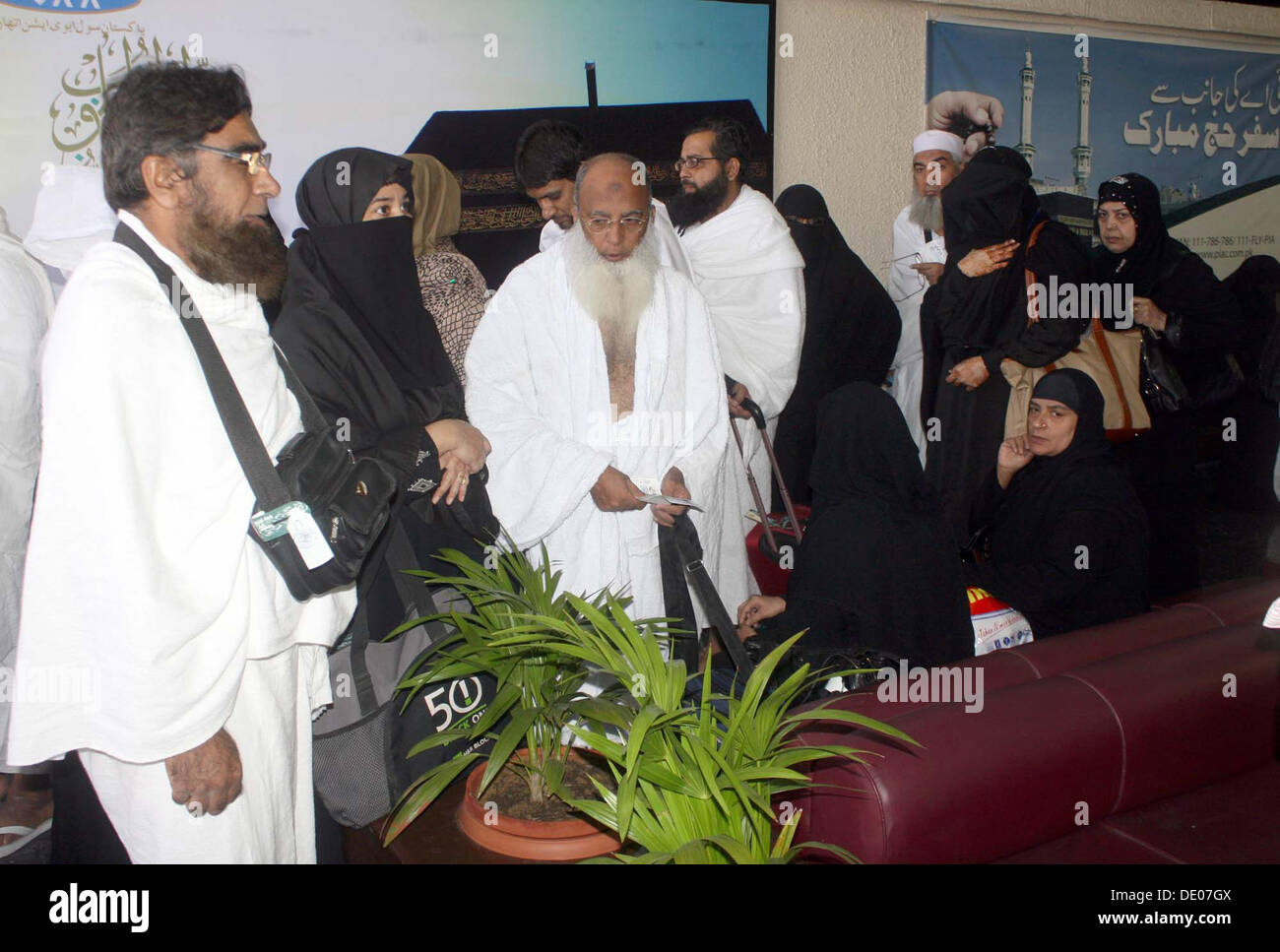 Pakistani pilgrims are waiting at Jinnah International Airport Hajj ...