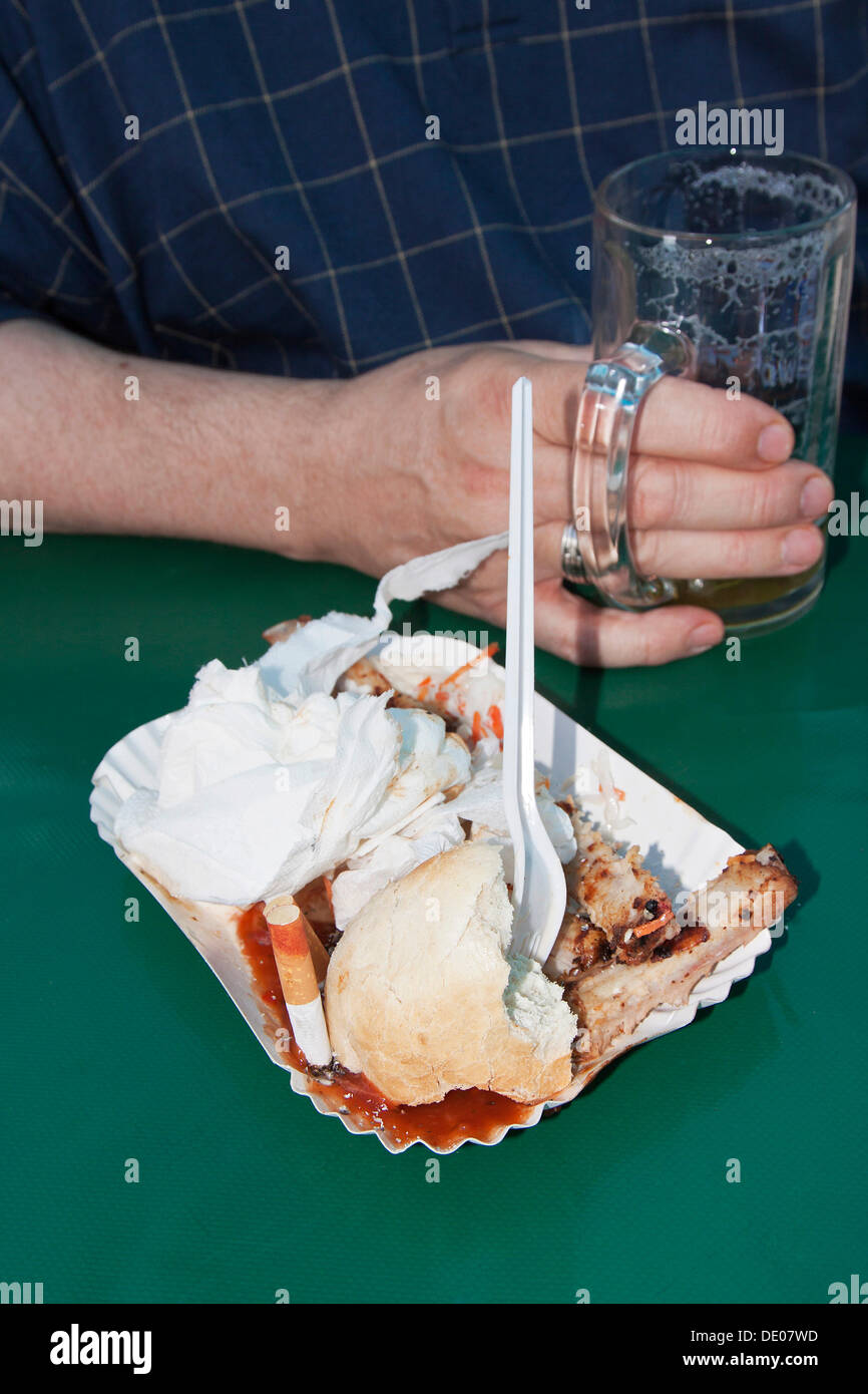 Squeezed out cigarette, leftover food, symbolic image for table manners ...