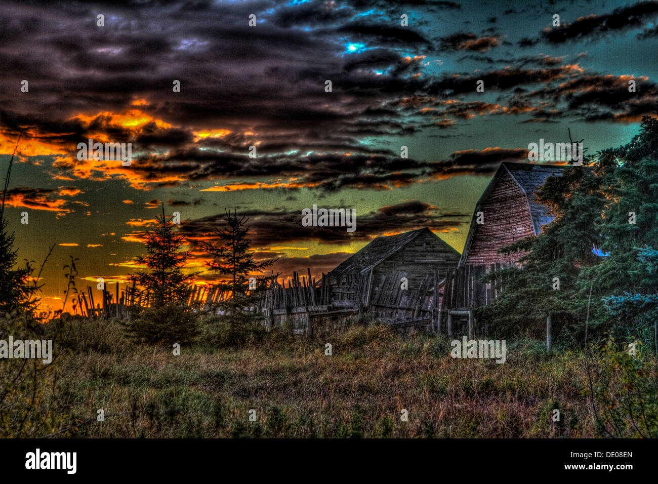 Old farm buildings at sunrise. Beautiful colors of dramatic orange ...