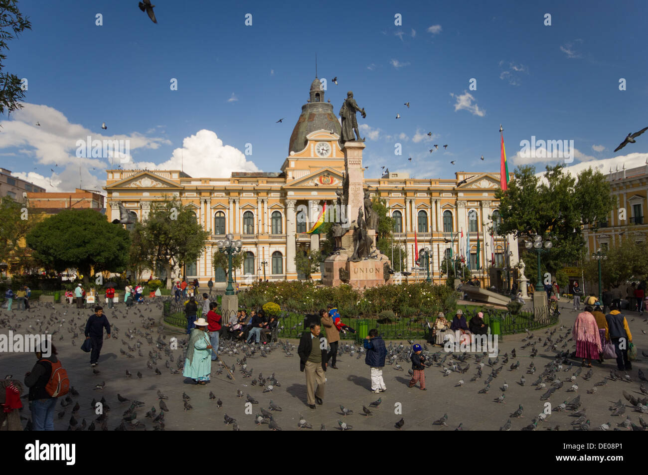 Locals amidst pigeons in front of the National Congress of Bolivia ...