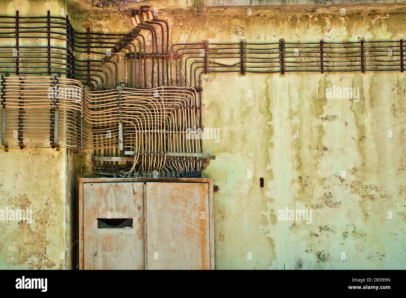 Old electric installations, obsolete room interior with old electric ...