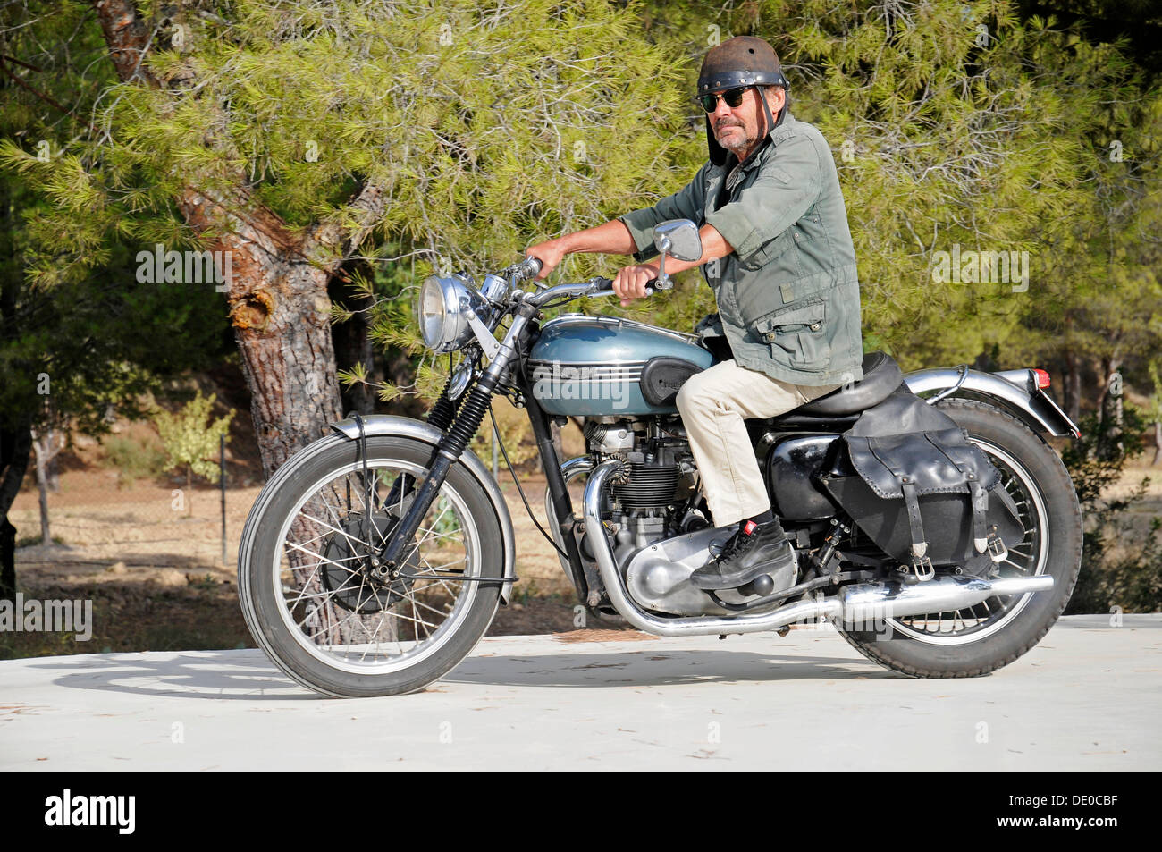Elderly man riding a Triumph Tiger 500cc motorbike, built in 1956 ...