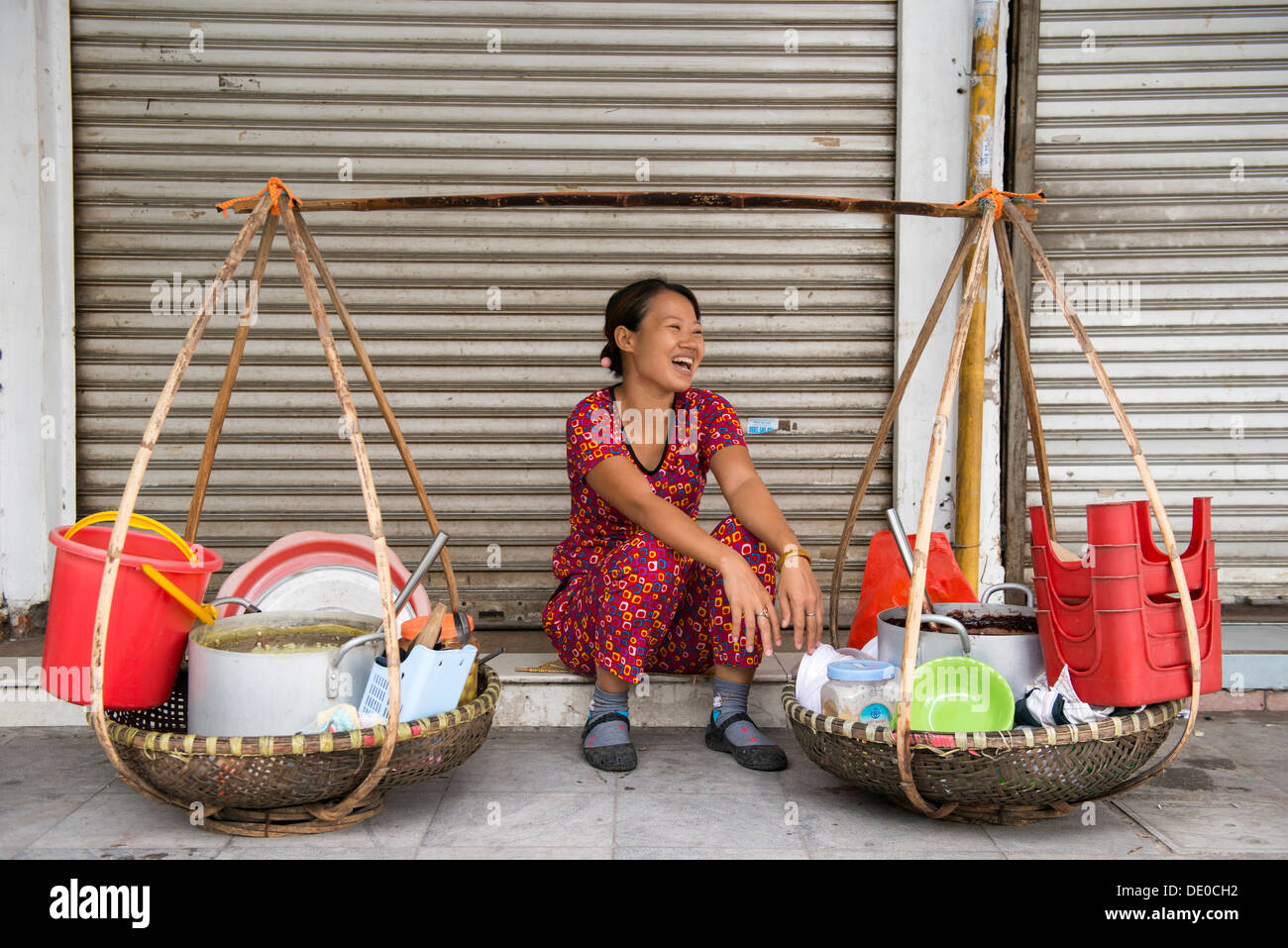 Vietnamese peddling food seller take brake beside of old street at ...