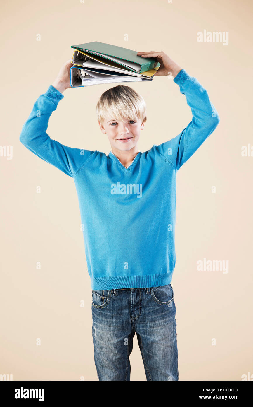 Boy holding folders Stock Photo - Alamy